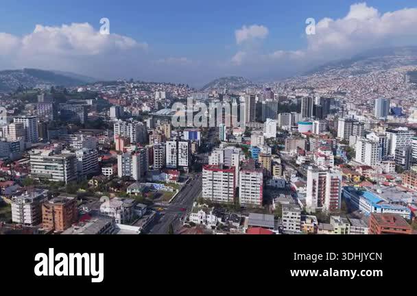 Urban landscape of Quito stretching across mountain valley, revealing ...