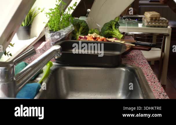 Kitchen sink with vegetables and cooking utensils Stock Video Footage ...