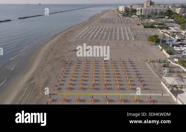 Aerial footage of sandy beach with umbrellas,gazebos and background ...