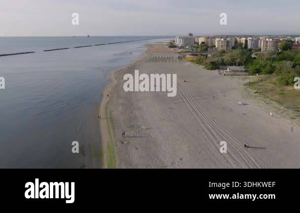 Aerial view of sandy beach with umbrellas,gazebos and background town ...