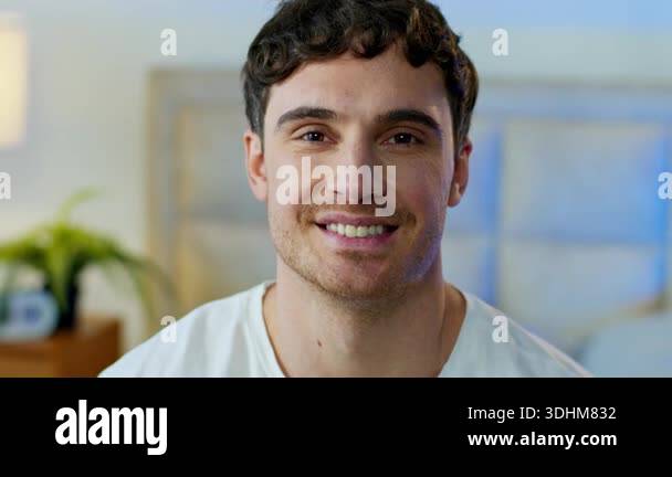 Close up joyful Caucasian young man smiling looking at camera toothy ...