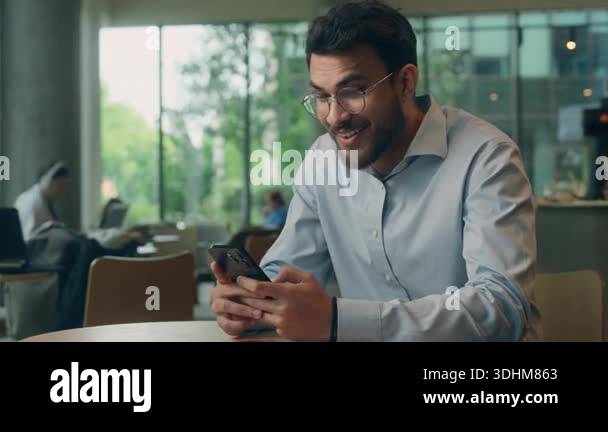 Indian smiling satisfied businessman using mobile phone app looking at ...