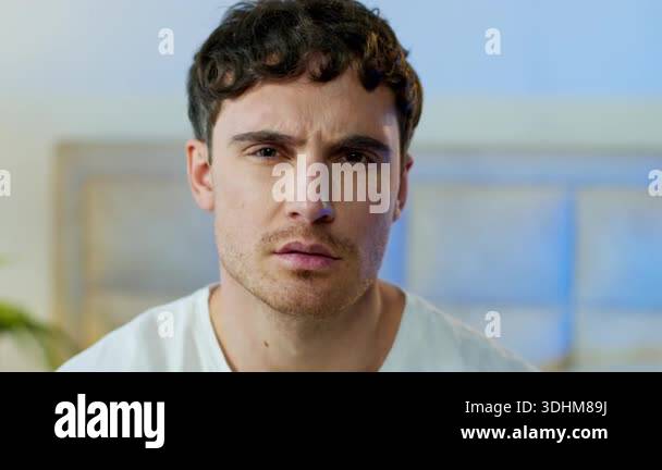 Disgusted confused young Caucasian man frowning looking at camera ...