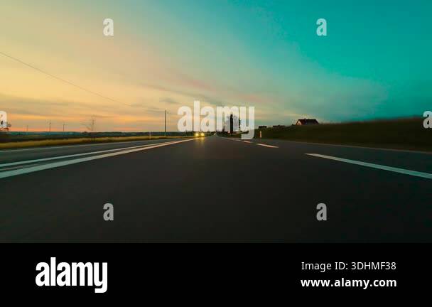 POV driving on asphalt road at sunset with headlights on. Point of view ...