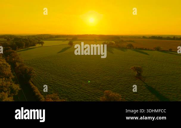 Golden sunset over farmlands in the United Kingdom. Vast English fields ...