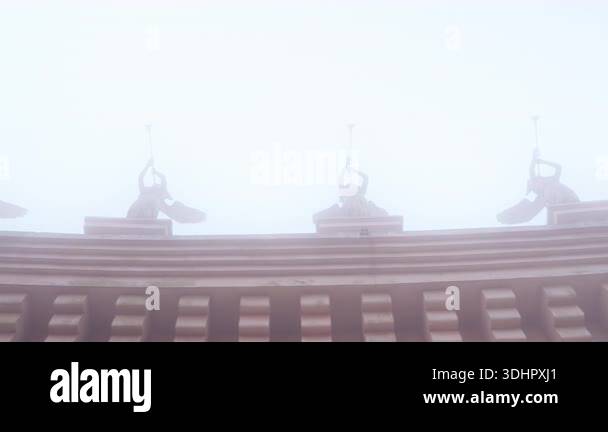 Row of angel Statues holding trumpets barely visible in bright Fog at ...