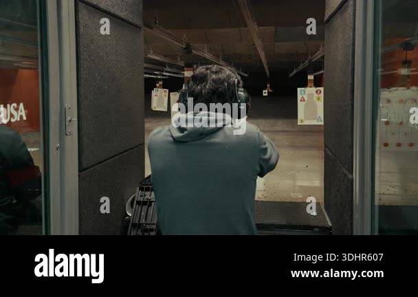 POV of person actively shooting a handgun at paper targets inside ...