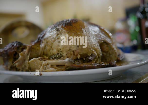 Golden roasted whole juicy chicken turkey on plate with herbs and ...