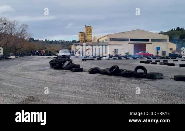 Cars drifting around tires on asphalt track Stock Video Footage - Alamy