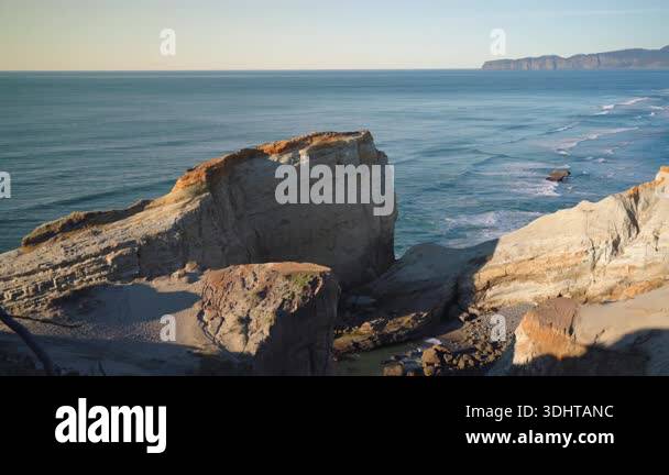 Rocky coastal cliffs overlook calm Pacific Ocean along Oregon Coast ...