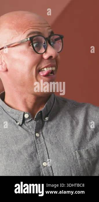 A man wearing glasses displays a range of humorous facial expressions ...