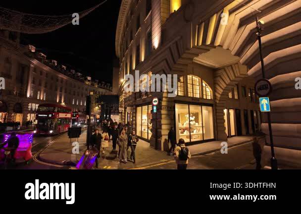 LONDON, UK - JANUARY 8, 2026 - Londoners walking past illuminated ...