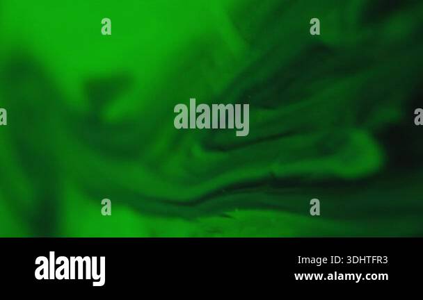 Acrylic mix. Emulsion flow. Defocused green color ink fluid liquid ...