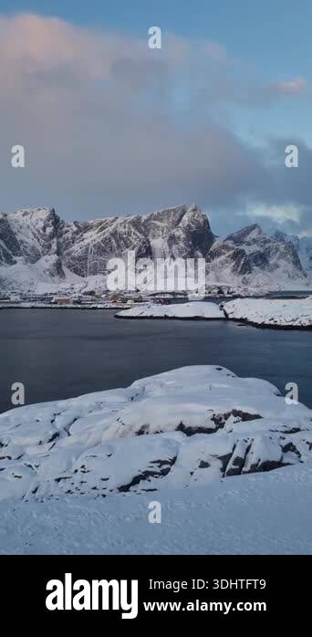 Beautiful view of nordic fishing village on coastline with snow covered ...