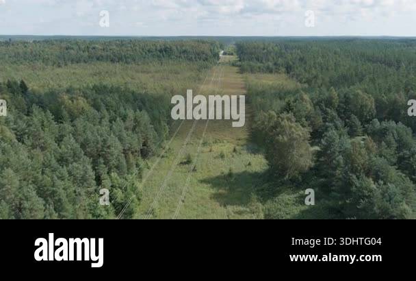 Aerial view of power line corridor in cloudy summer weather, Harparskog ...