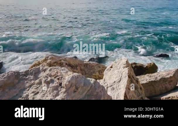 boulders meeting crashing turquoise waves, foamy spray and limestone ...