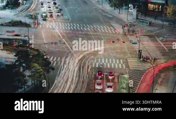 An urban traffic scene shows vehicles navigating an intersection at ...