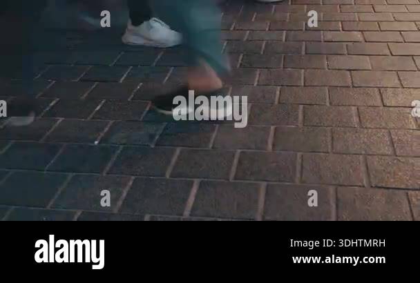 The video captures the continuous movement of footsteps on a textured ...