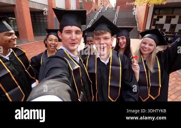 Happy group of diverse university students wearing graduation gowns and ...