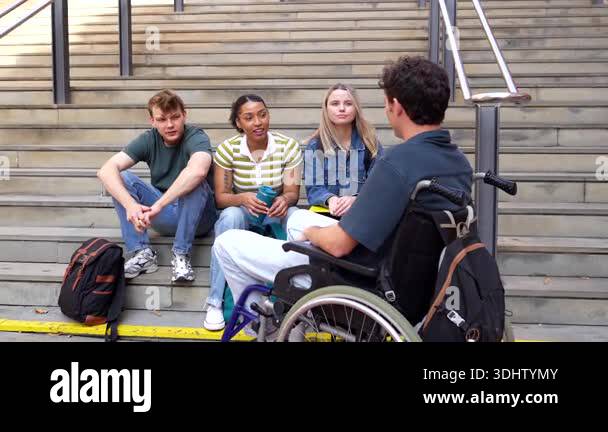 Group of multicultural young friends, including a man with a physical ...