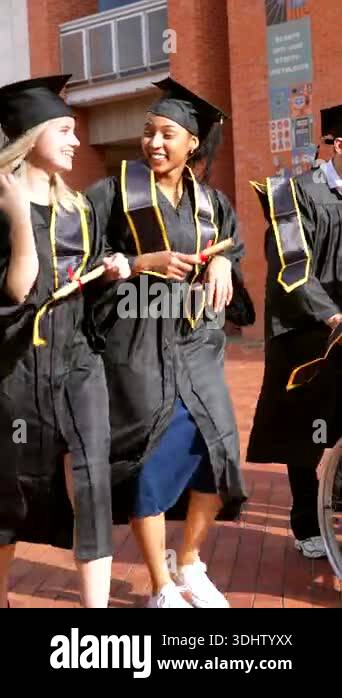 Happy multiracial group of students celebrating their university ...