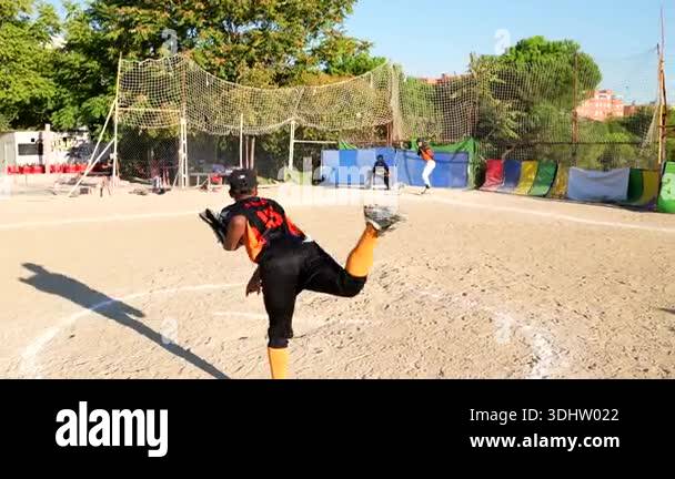 Young baseball pitcher throwing a fastball from the pitchers mound to a ...