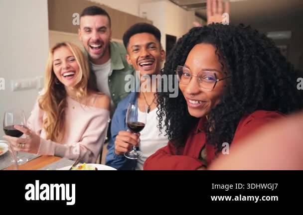 A cheerful group of friends happily celebrating together, sharing ...