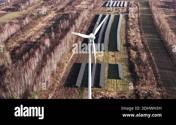 Solar photovoltaic panels and wind turbine aerial shot Stock Video ...