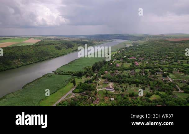 Aerial River Valley Village Under Overcast Sky, Winding River Bordering ...