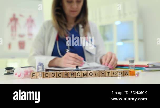 Wooden cubes spell word Pheochromocytoma near organ model and syringe ...