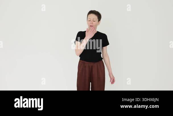 Woman in casual clothes sneezes and starts spinning around as turns ...