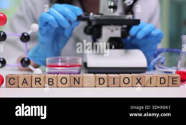 Woman researcher examines material closely under modern microscope ...