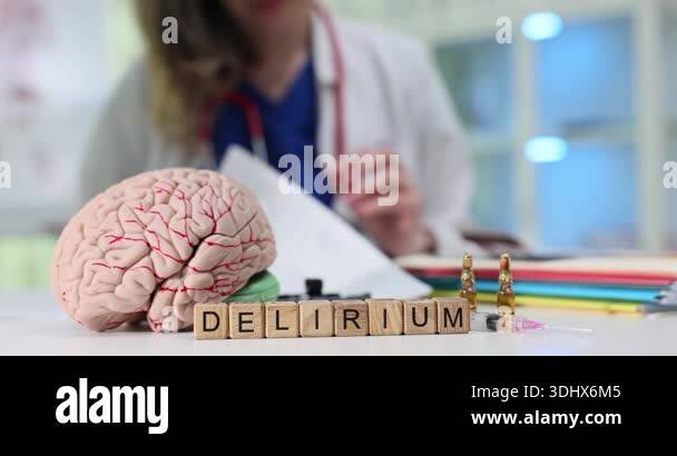 Word Delirium on blocks and human brain model on doctor desk. Woman ...