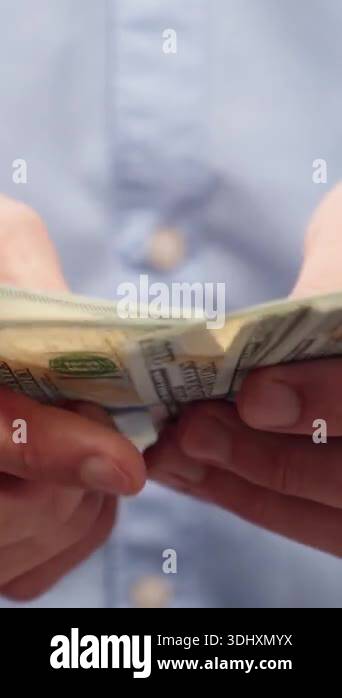 Close-up of male hands counting US dollar bills. Man in blue shirt ...