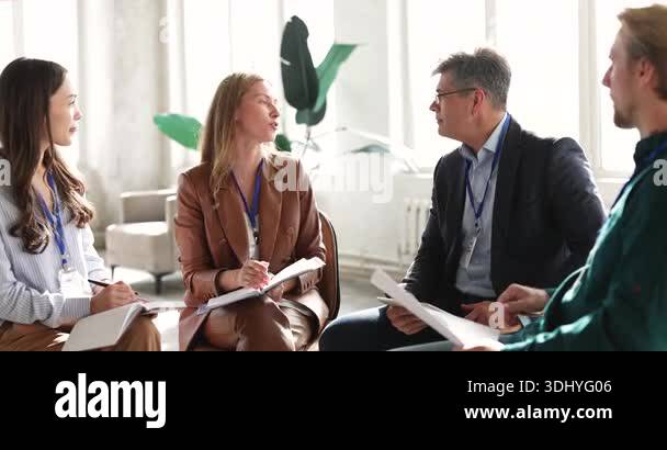 Female professional leading team discussion, explaining ideas ...