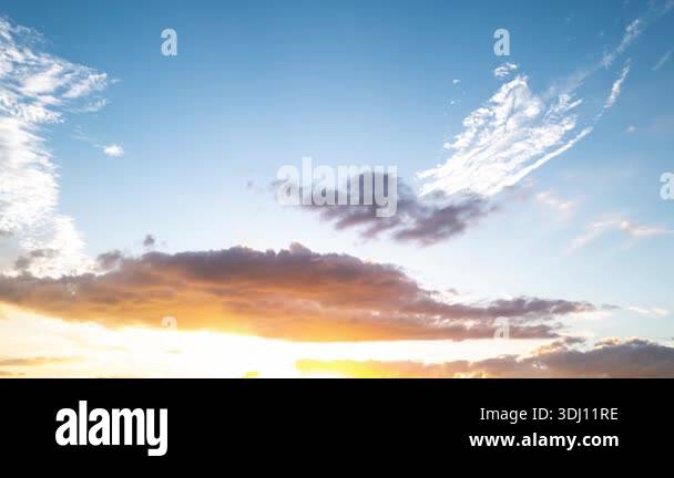 Fast moving clouds create a cinematic time lapse sky. Colorful sunset ...