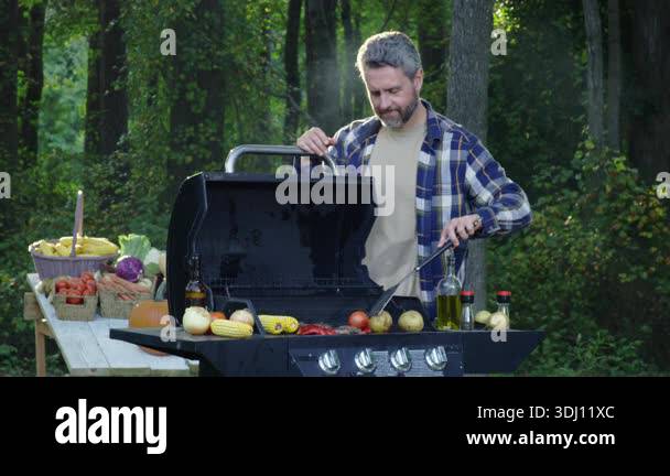 Backyard barbeque with chill. Man cooking tasty grill. Barbeque scene ...