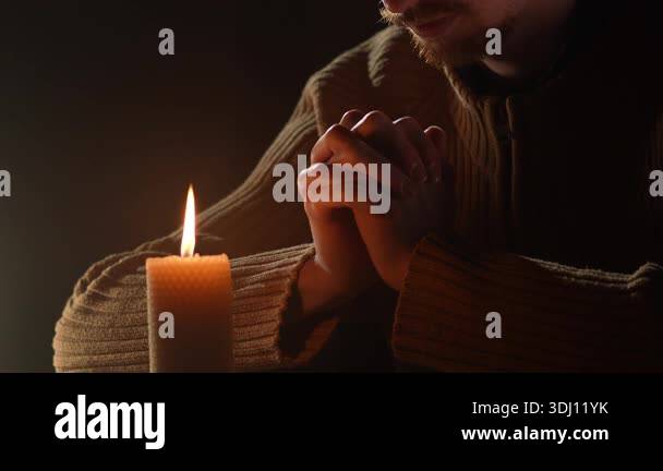 man prayer praying with burning candle, close-up. Religion concept ...