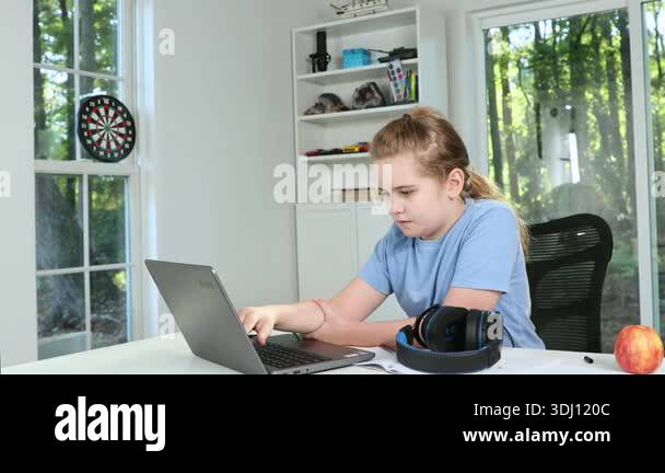 Kid studying at desk. Child doing homework on laptop. Boy doing home ...