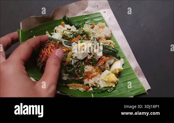 Footage of traditional Javanese mixed rice with fresh vegetables ...