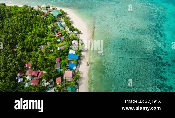 Houses in coastal area of Logbon Island. White sand beach in Romblon ...