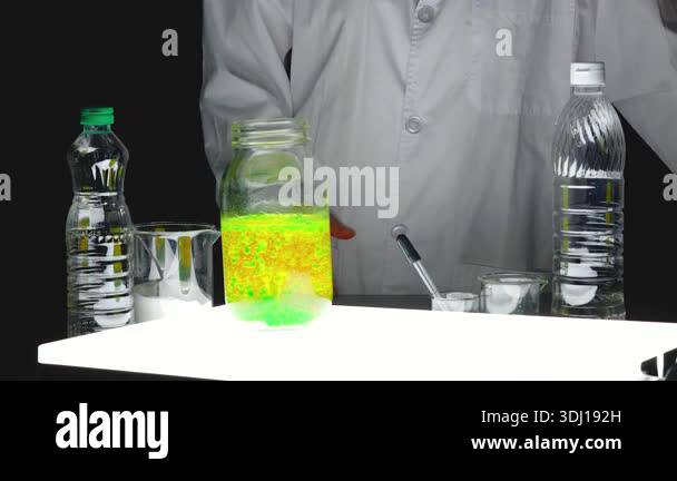 A person demonstrates a homemade lava lamp experiment using oil, water ...
