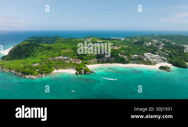 Beach resorts with white sands and tourist boat running over ...