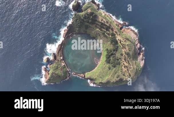 Stunning top down aerial shot flying over the volcanic crater of vila ...