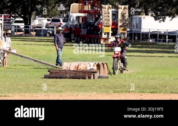 Motorcyclist performing a log jump in a field Stock Video Footage - Alamy