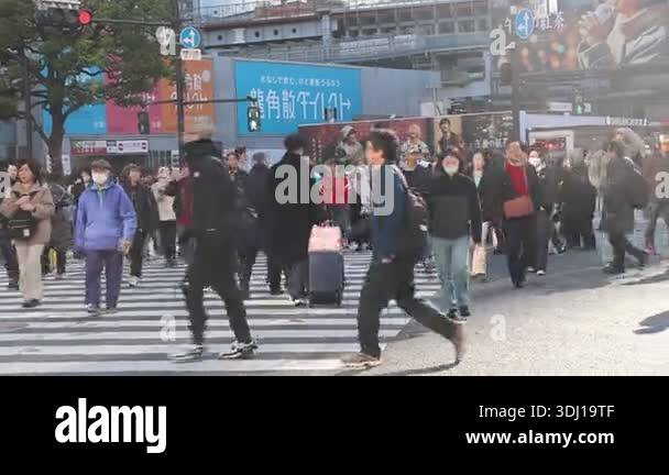 Tokyo, Japan- 16 Dec 2025: People crossing the iconic Shibuya Scramble ...