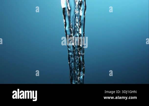 A single vertical stream of clear water falling against a light blue ...