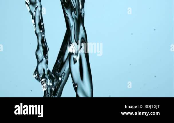 Two streams of clear pure liquid water pouring and crossing in slow ...