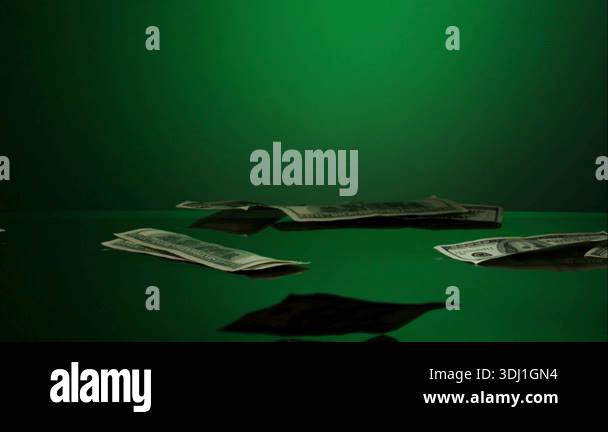 American hundred dollar bills falling and floating slowly down onto a ...