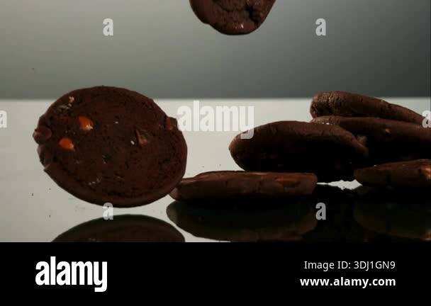 Delicious round chocolate chip cookies with white nuts falling and ...